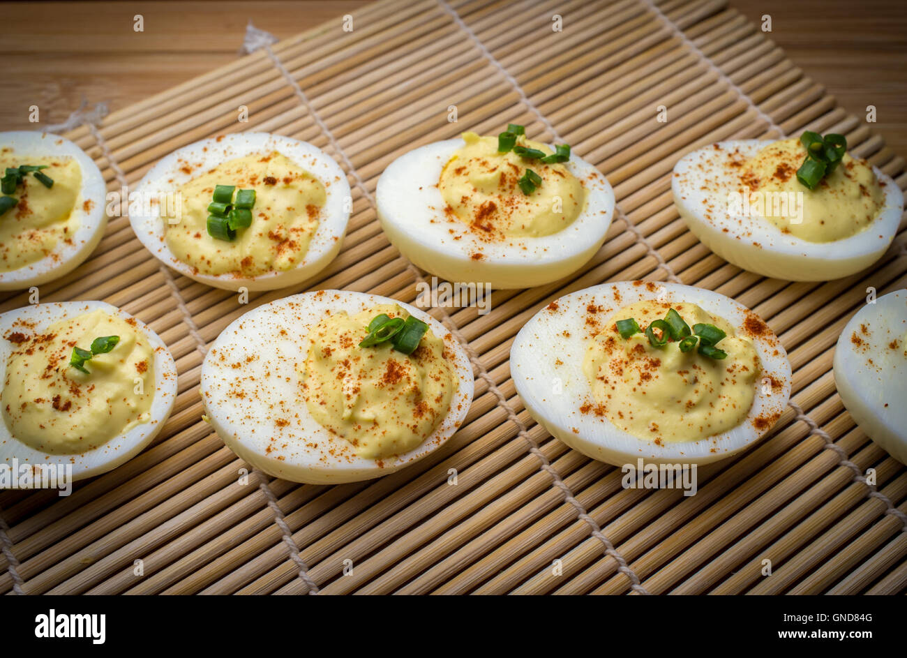 Stuffed Russian deviled eggs topped with chives and paprika Stock Photo - Alamy