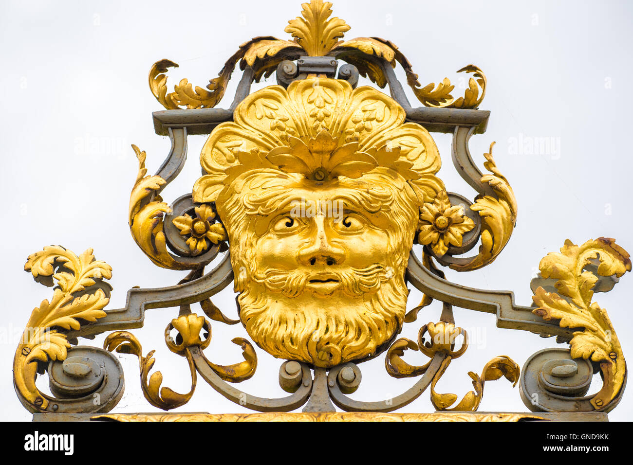 Gilded face on a gate at Hampton Court palace, London Stock Photo - Alamy