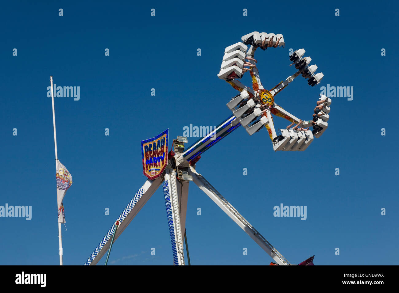 Beach party pendulum twister ride on Coney Beach Stock Photo - Alamy