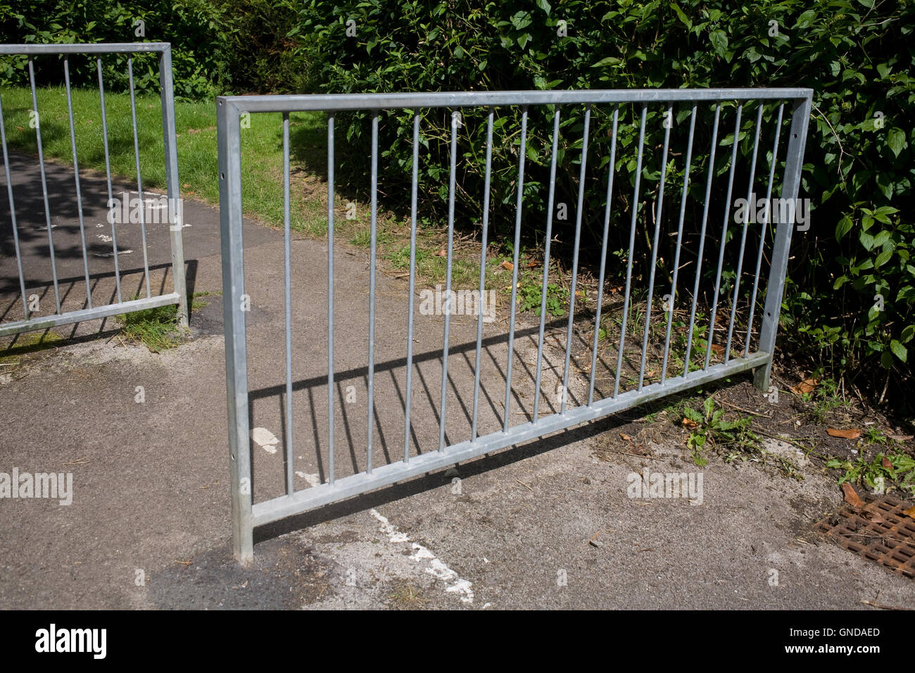 Rectangular safety barriers on footpath in housing estate in Bridgend ...
