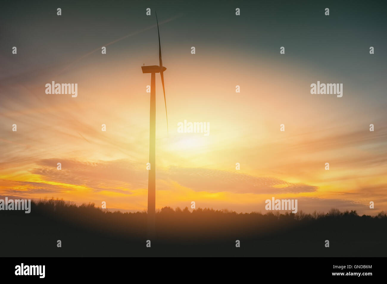 Wind turbine farm with rays of light at sunset Stock Photo - Alamy
