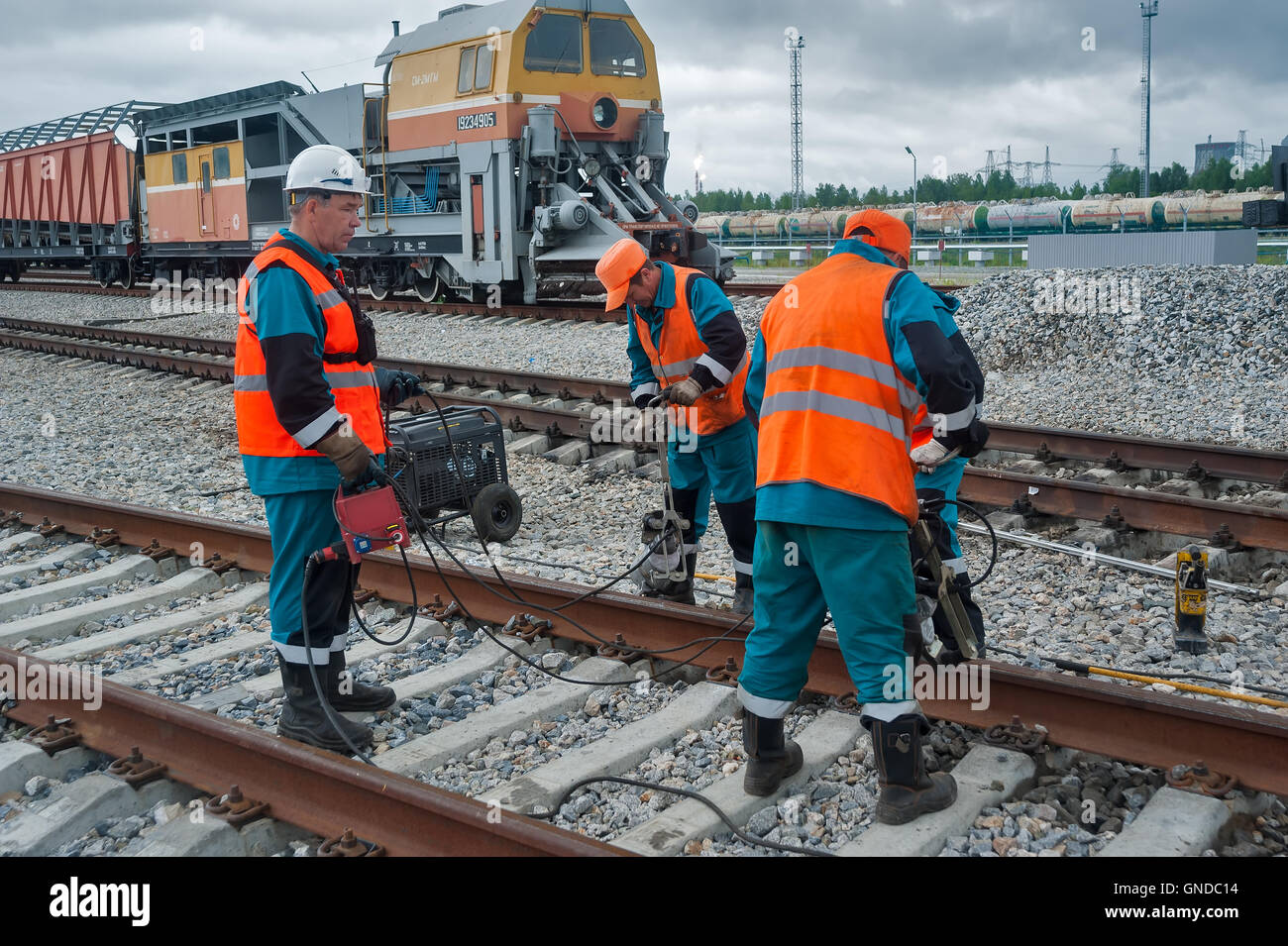 Railway workers repairing rail Stock Photo - Alamy
