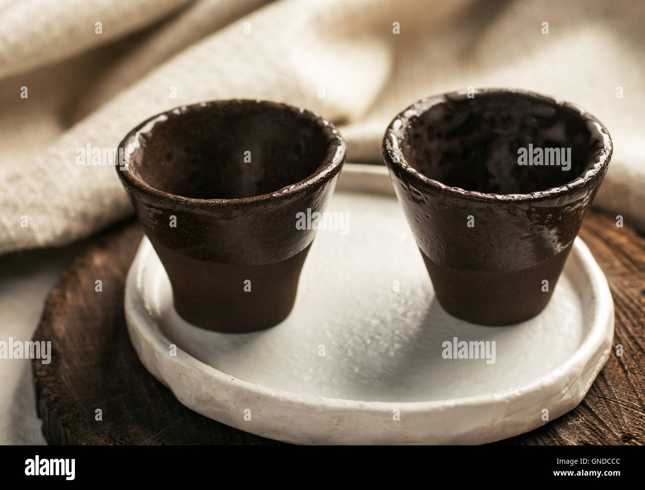Clay pots and plate on linen Stock Photo - Alamy