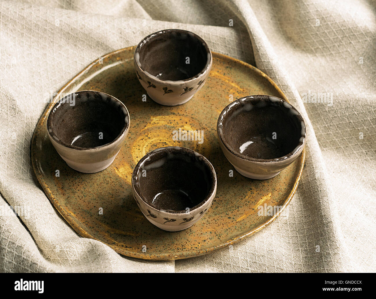 Clay pots and plate on linen Stock Photo - Alamy