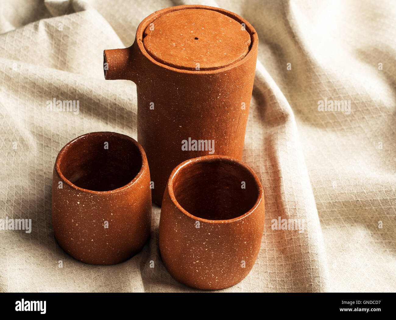 Clay pots and plate on linen Stock Photo - Alamy
