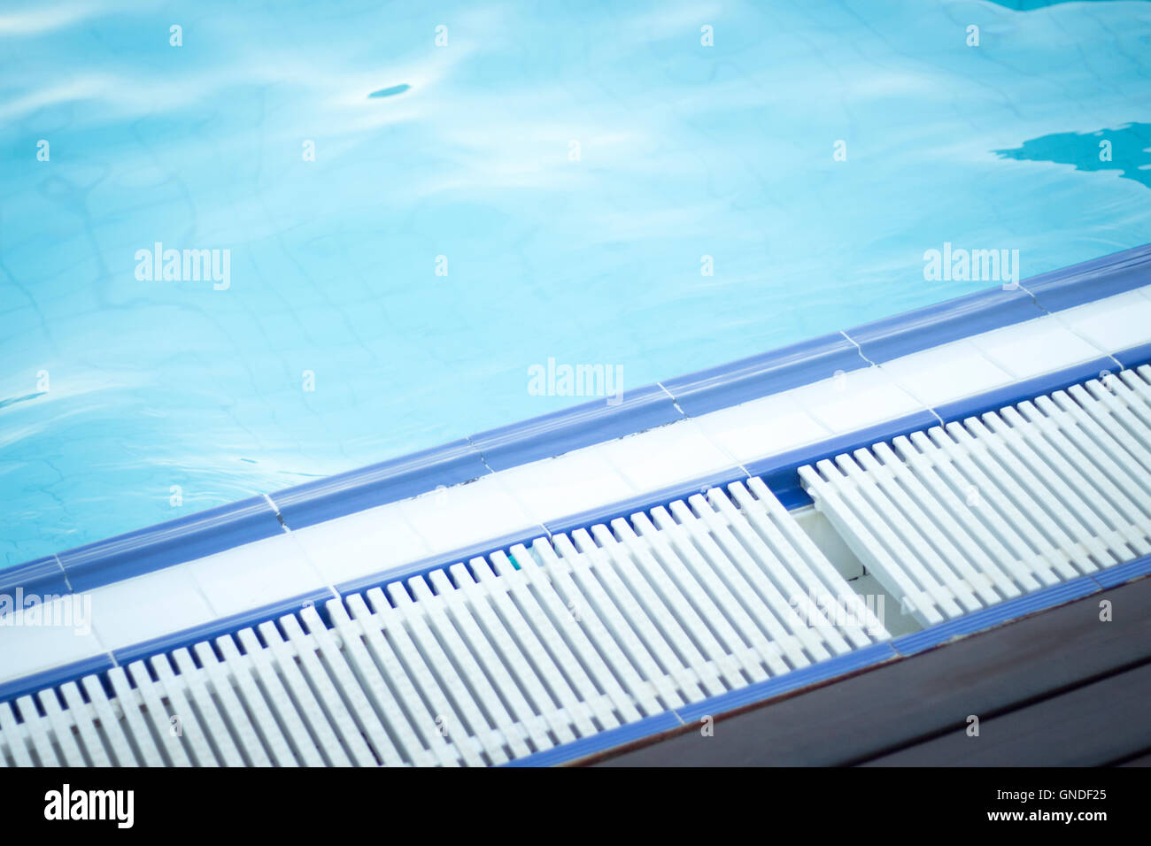 Hot summer by the outdoors swimming pool with wooden sundeck terrace ...