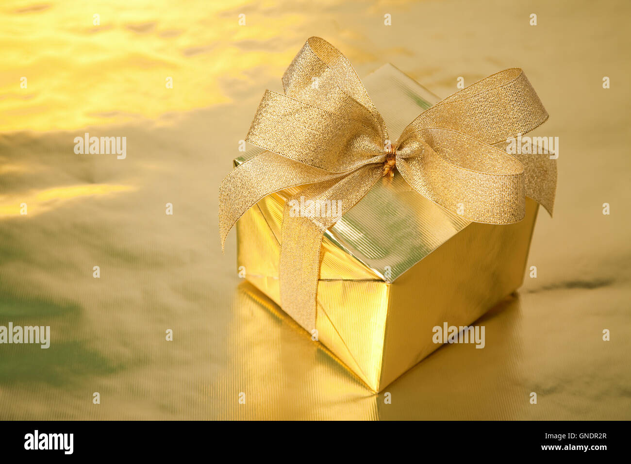golden gift box with bow Stock Photo - Alamy