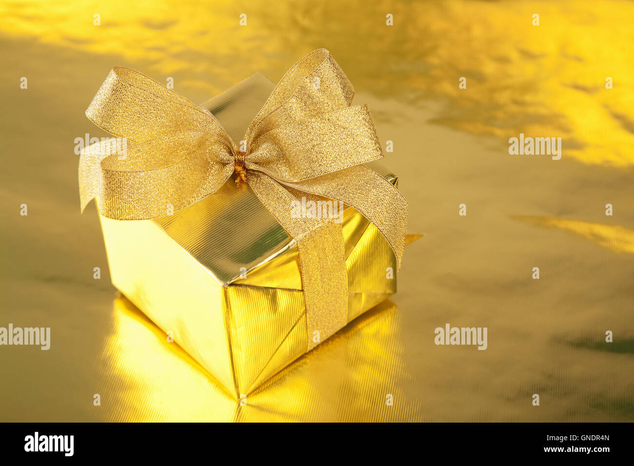 golden gift box with bow Stock Photo - Alamy