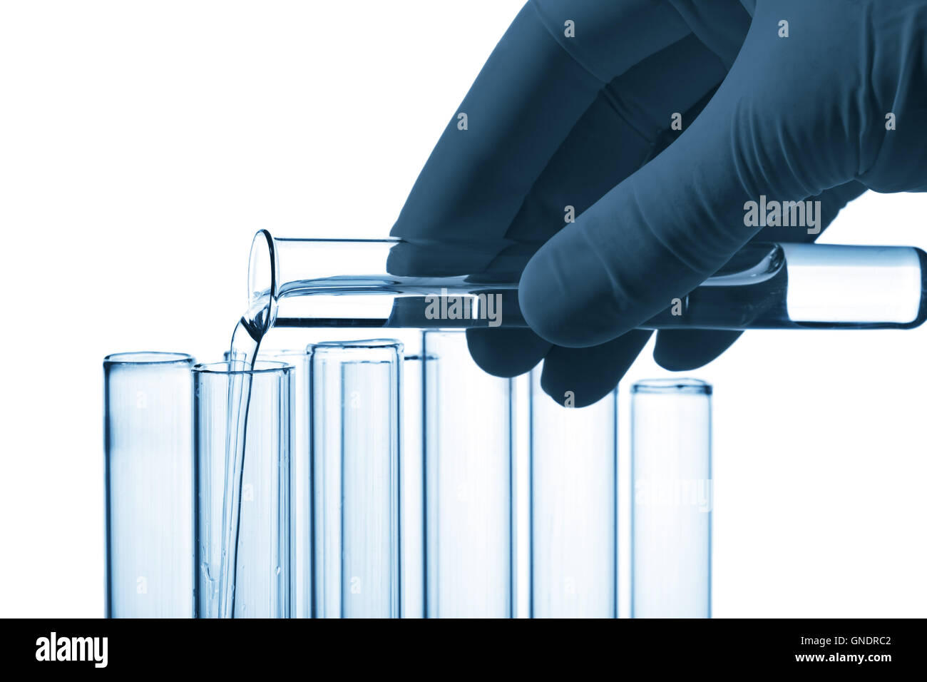 hand pouring liquid into test tube isolated Stock Photo - Alamy