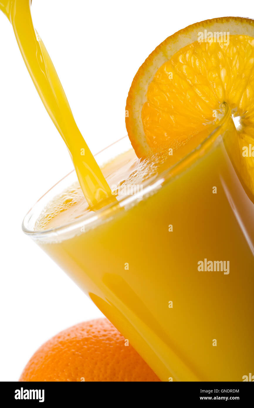 orange juice pouring into glass isolated Stock Photo - Alamy