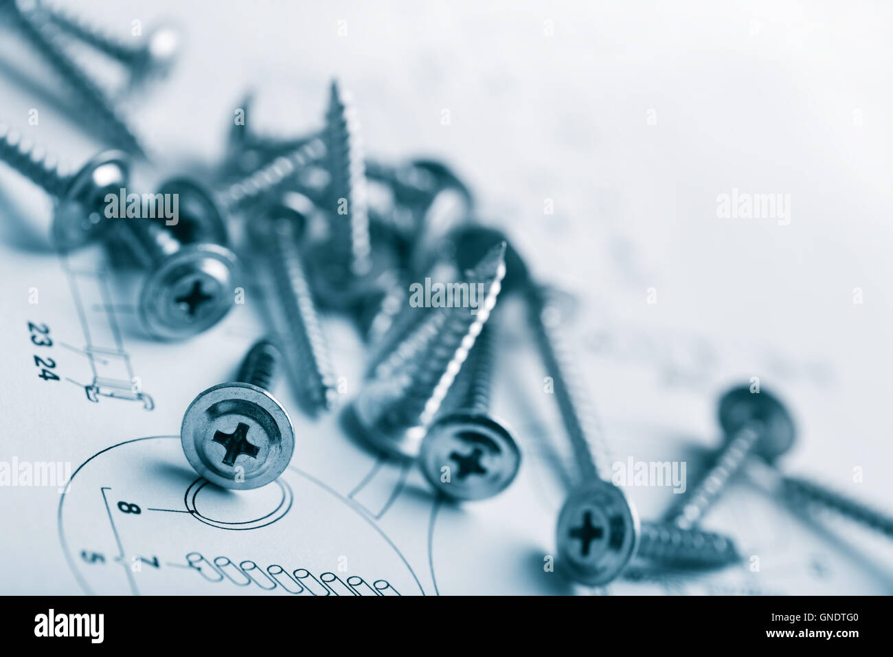 metal screws over technical drawing background Stock Photo - Alamy