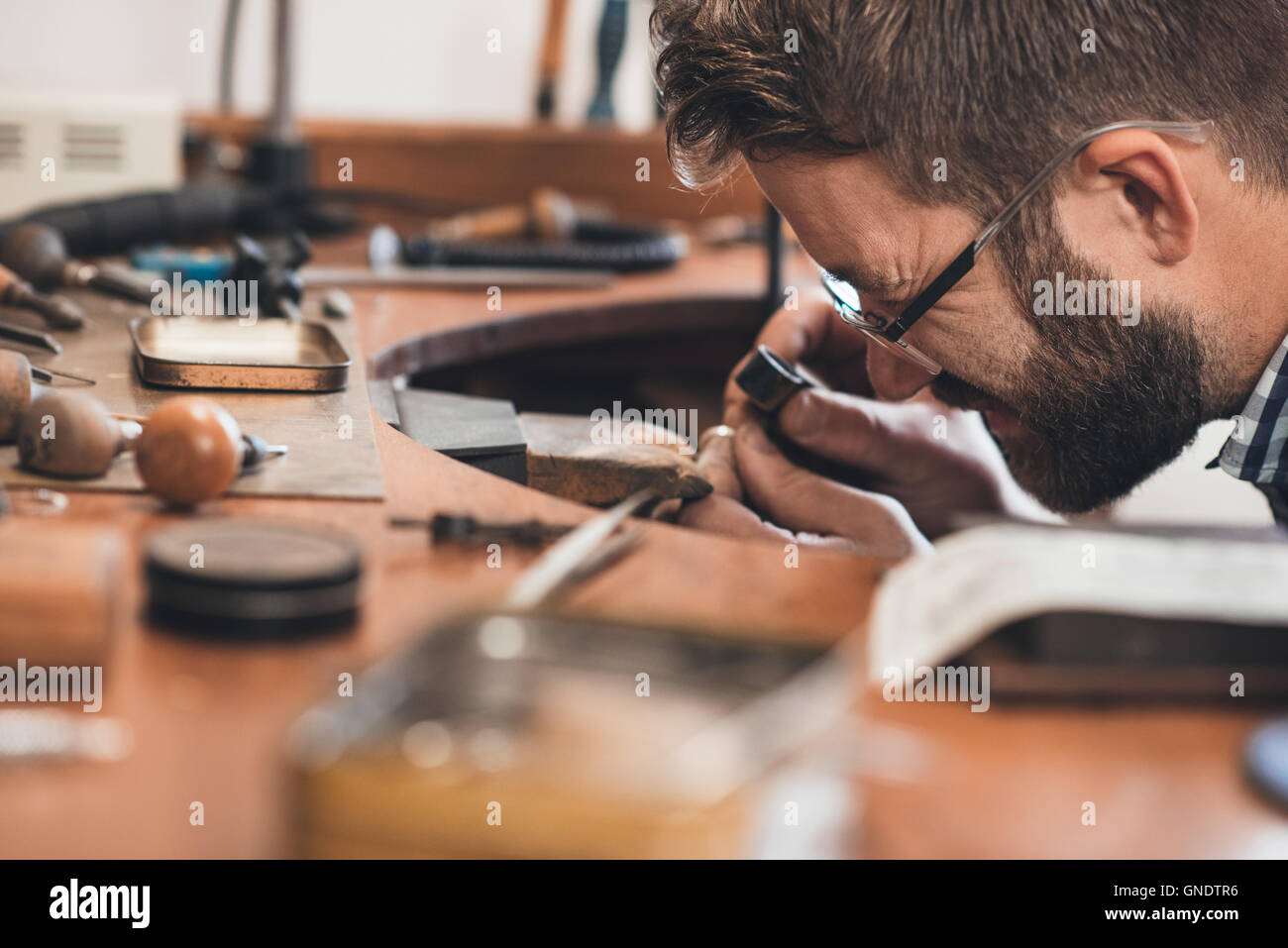 Giving his work a closeup inspection Stock Photo - Alamy