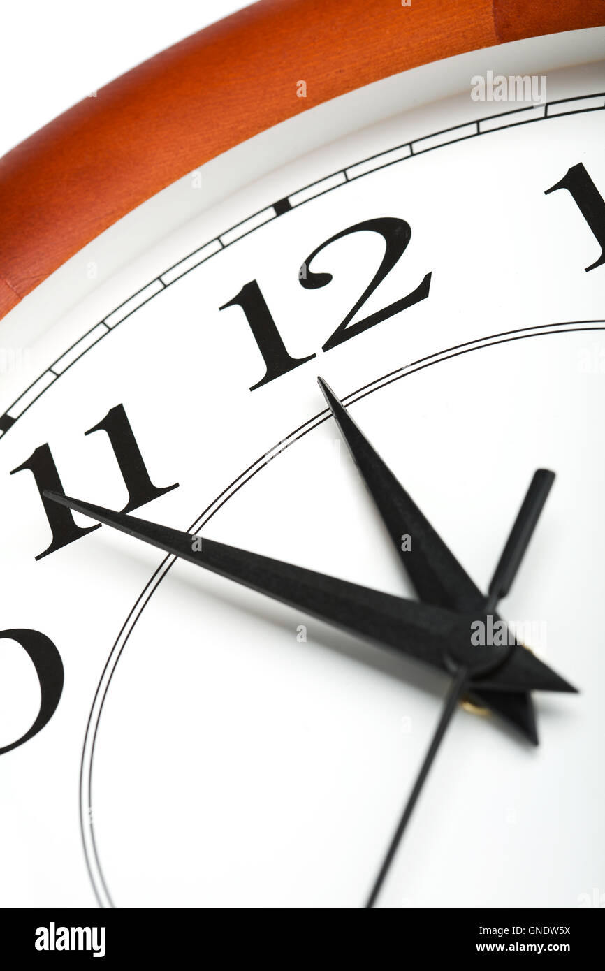 round clock showing time about twelve isolated Stock Photo - Alamy