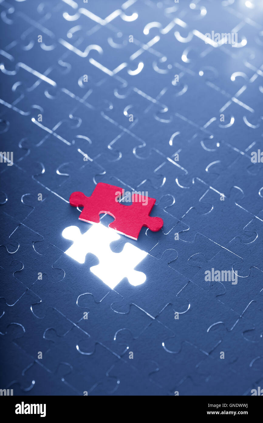 blue puzzle with one red piece Stock Photo - Alamy