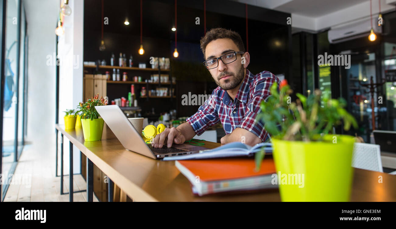 Handsome student studying in restaurant Stock Photo - Alamy