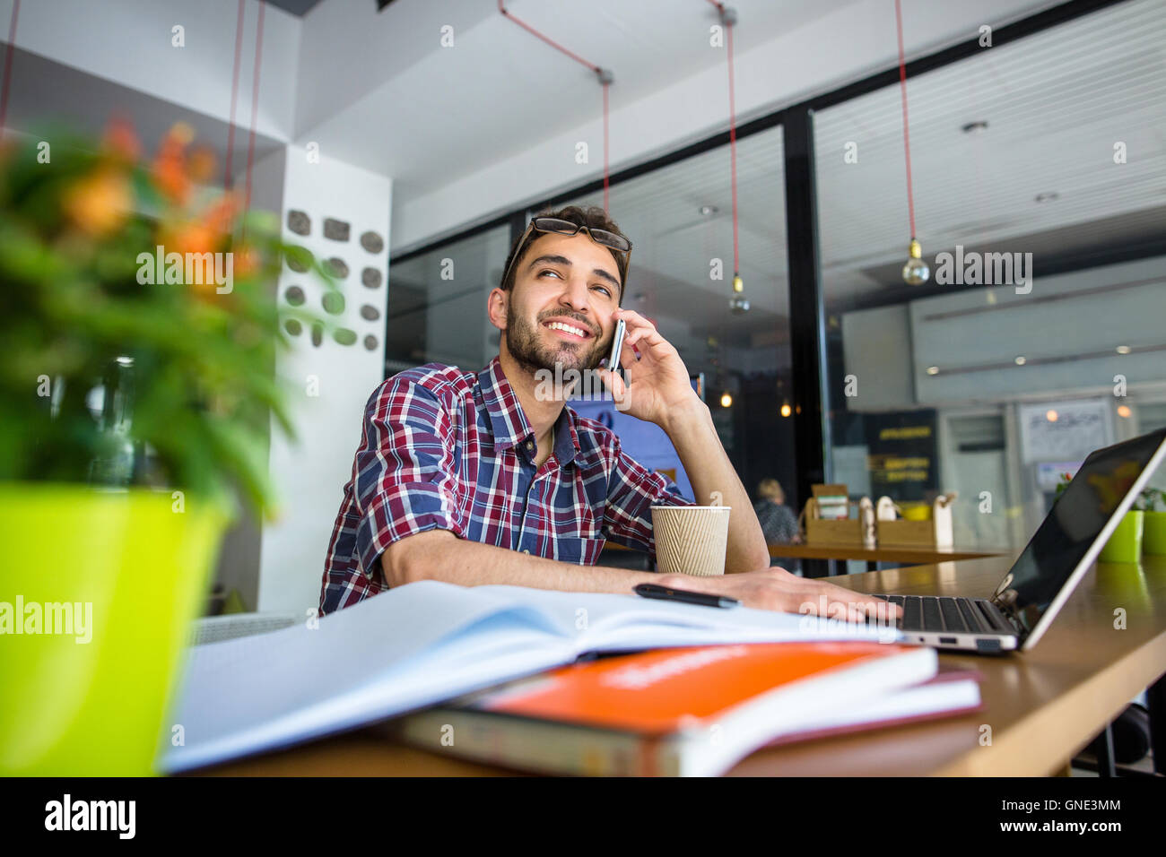 Handsome student studying in restaurant Stock Photo - Alamy