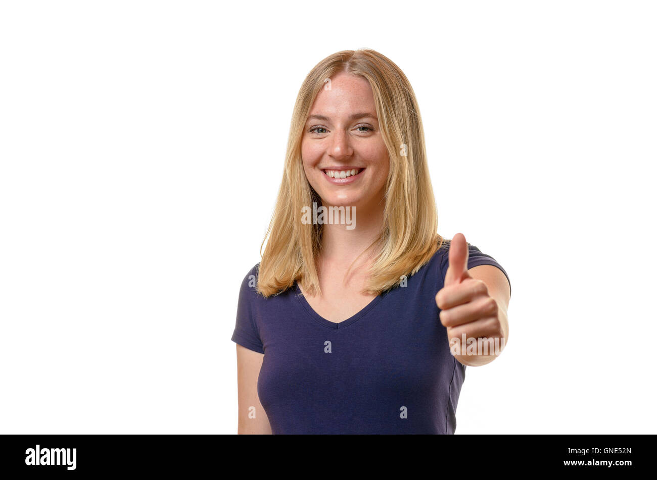 Elated attractive young blond woman giving a thumbs up gesture of ...