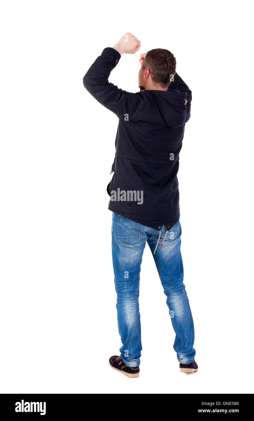 Back view of man. Raised his fist up in victory sign Stock Photo - Alamy