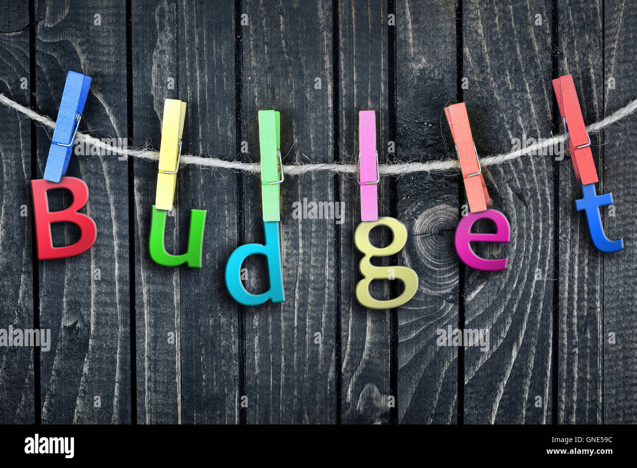 Budget word hanging on clips and wooden wall Stock Photo - Alamy