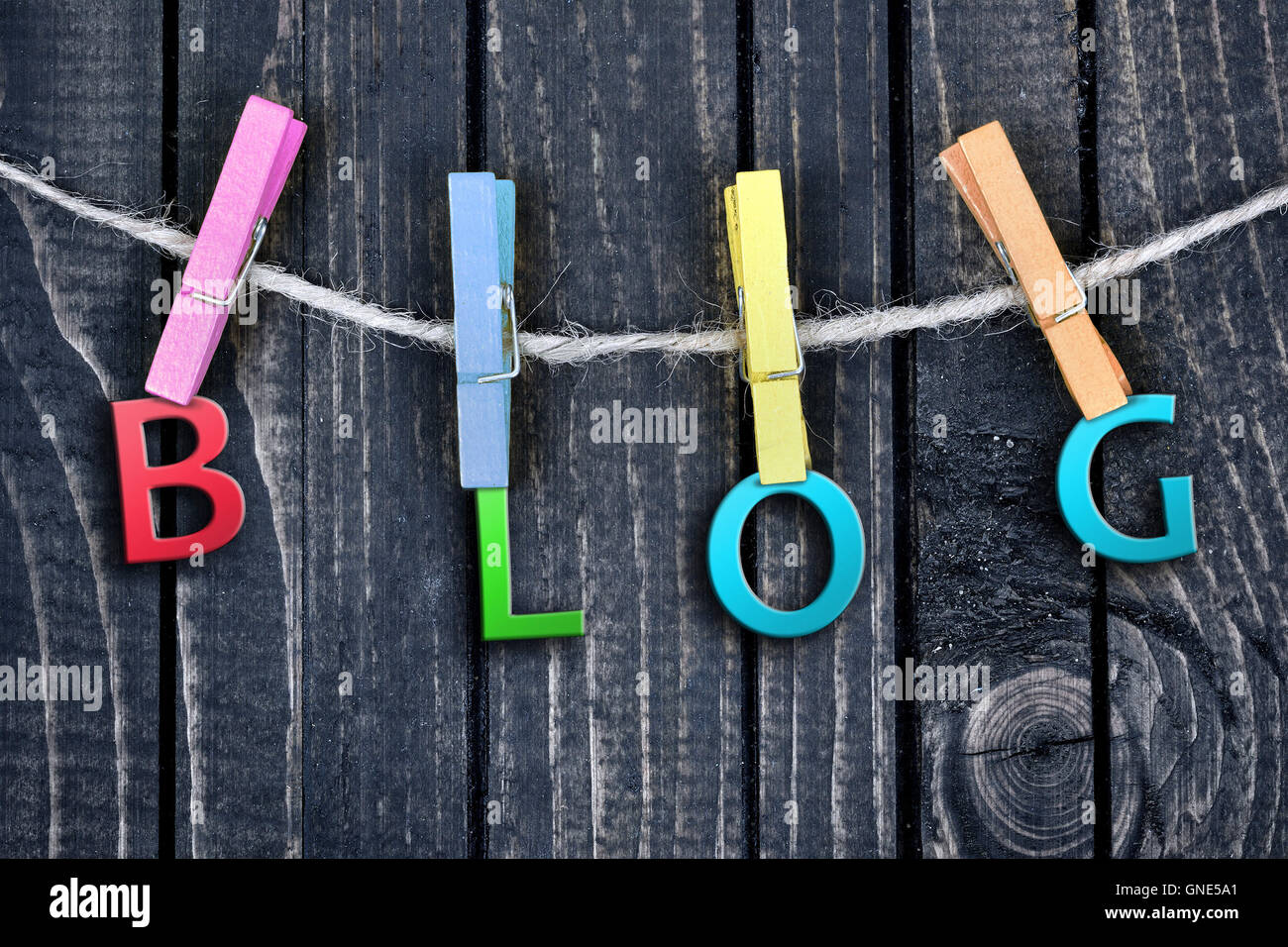 Blog word hanging on clips and wooden wall Stock Photo - Alamy