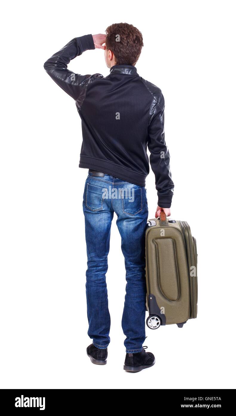 Back view of man with green suitcase looking up Stock Photo - Alamy