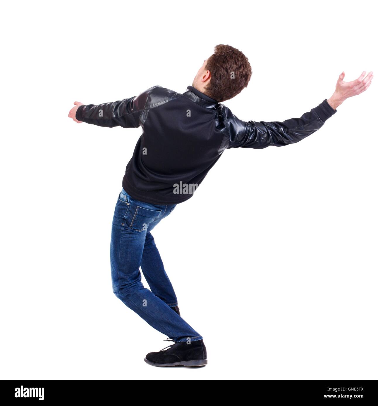 Balancing young man. or dodge the falling Stock Photo - Alamy