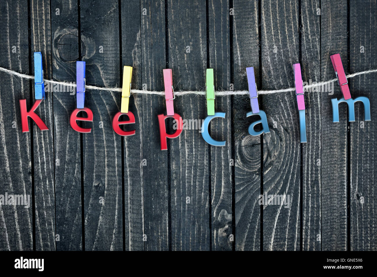 Keep Calm word hanging on clips and wooden wall Stock Photo - Alamy