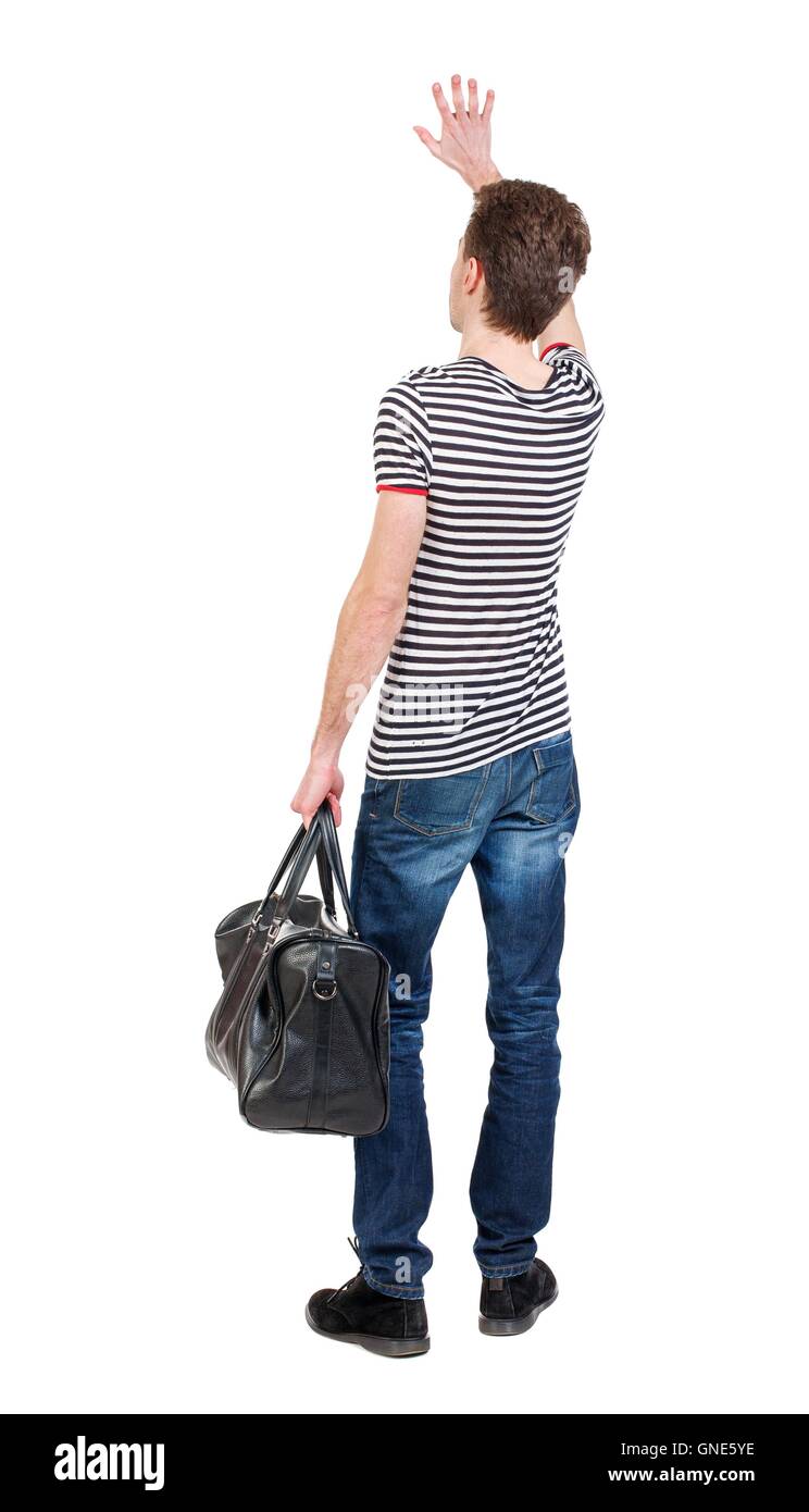 back view of man with a bag waving in greeting Stock Photo - Alamy