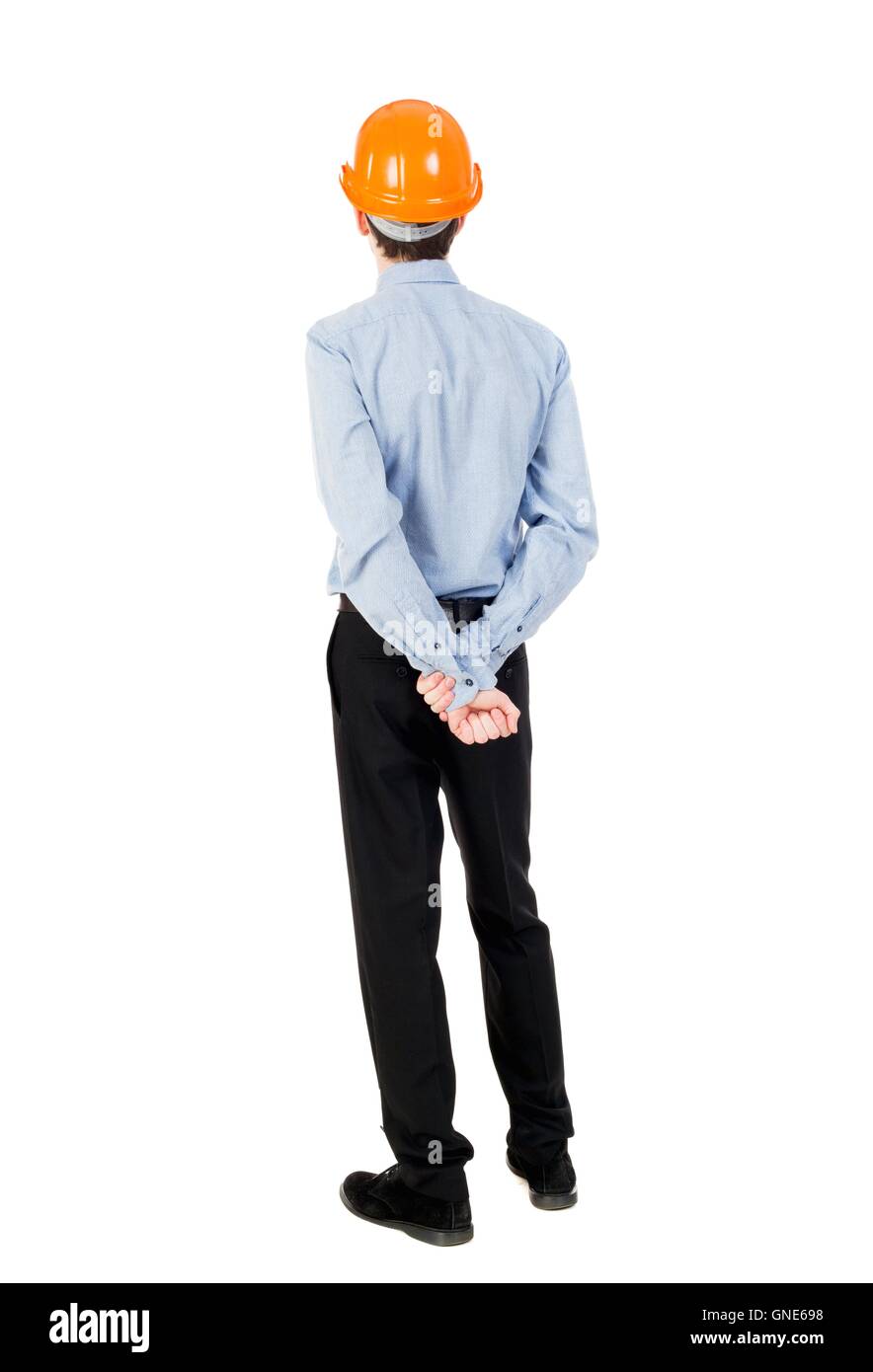 Backview of an engineer in construction helmet stands Stock Photo - Alamy