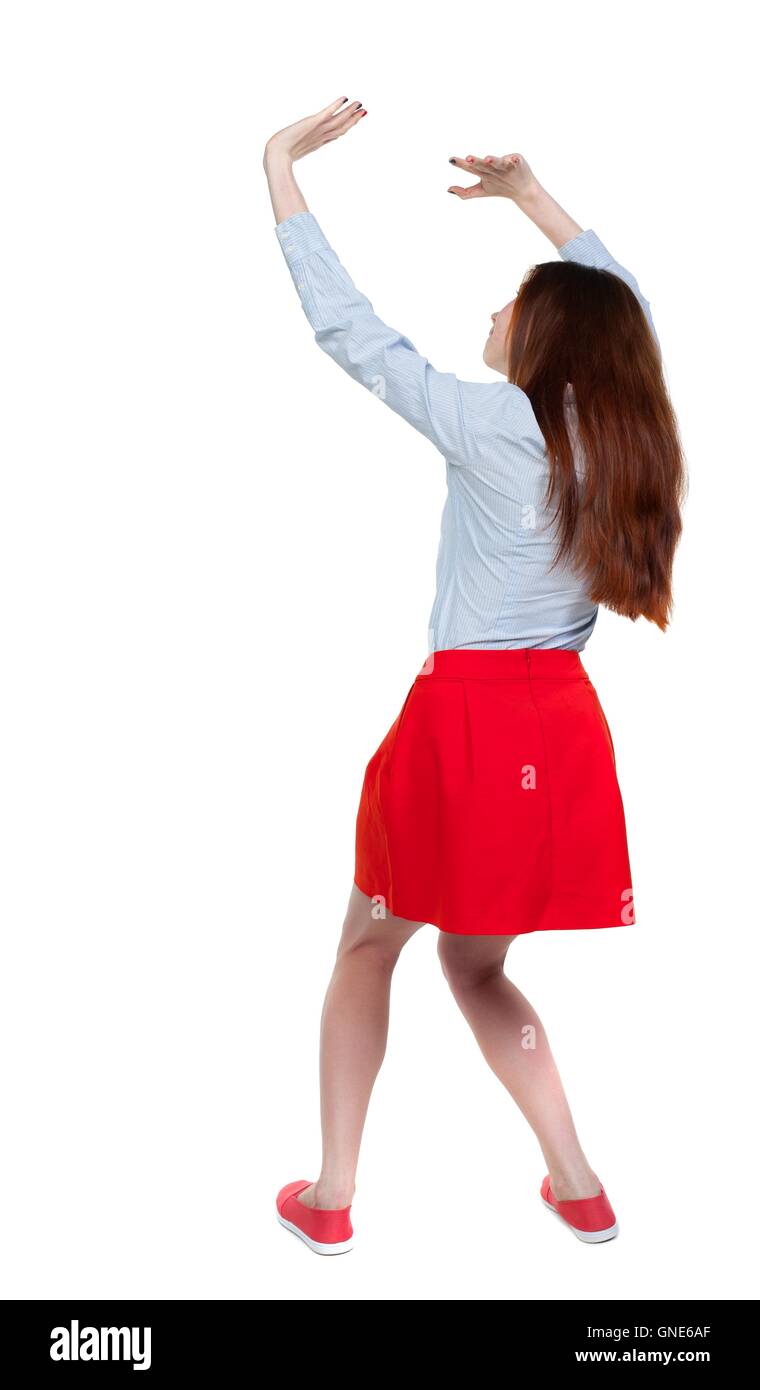 back view of woman protects hands from what is falling Stock Photo - Alamy