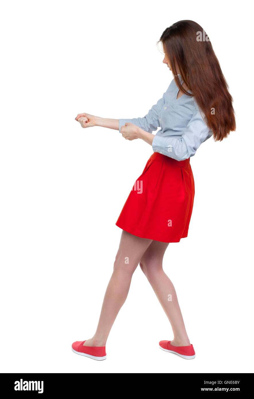 back view of standing girl pulling a rope from the top or cling Stock ...