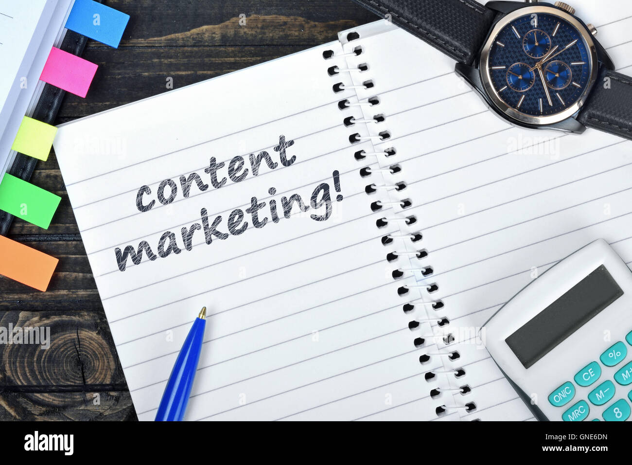 Marketing text on notepad and watch on desk Stock Photo - Alamy
