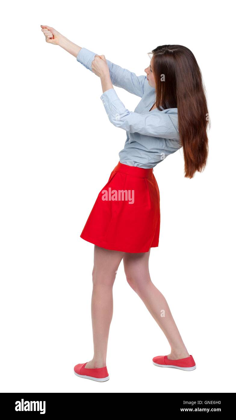 back view of standing girl pulling a rope from the top or cling Stock ...