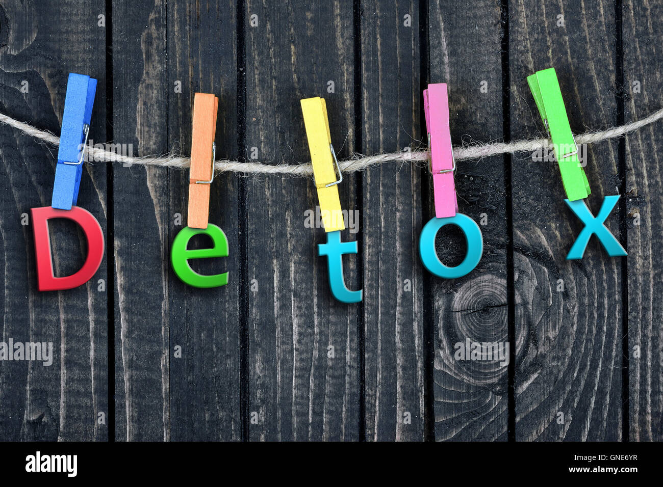 Detox word hanging on clips and wooden wall Stock Photo - Alamy