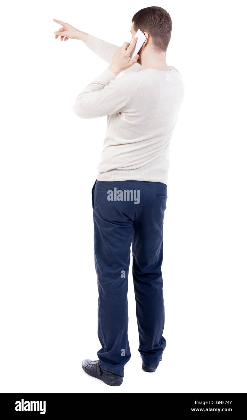 Back view of pointing young men talking on cell phone Stock Photo - Alamy