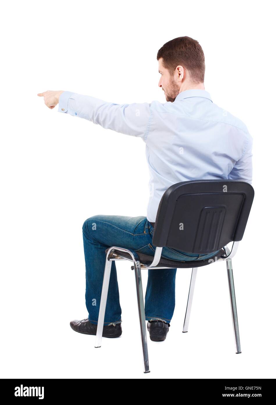 back view of young business man sitting on chair and pointing Stock ...