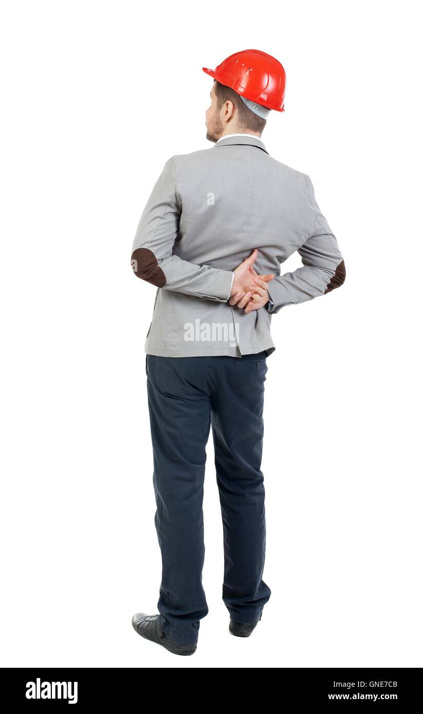 Backview of an engineer in construction helmet stands Stock Photo - Alamy