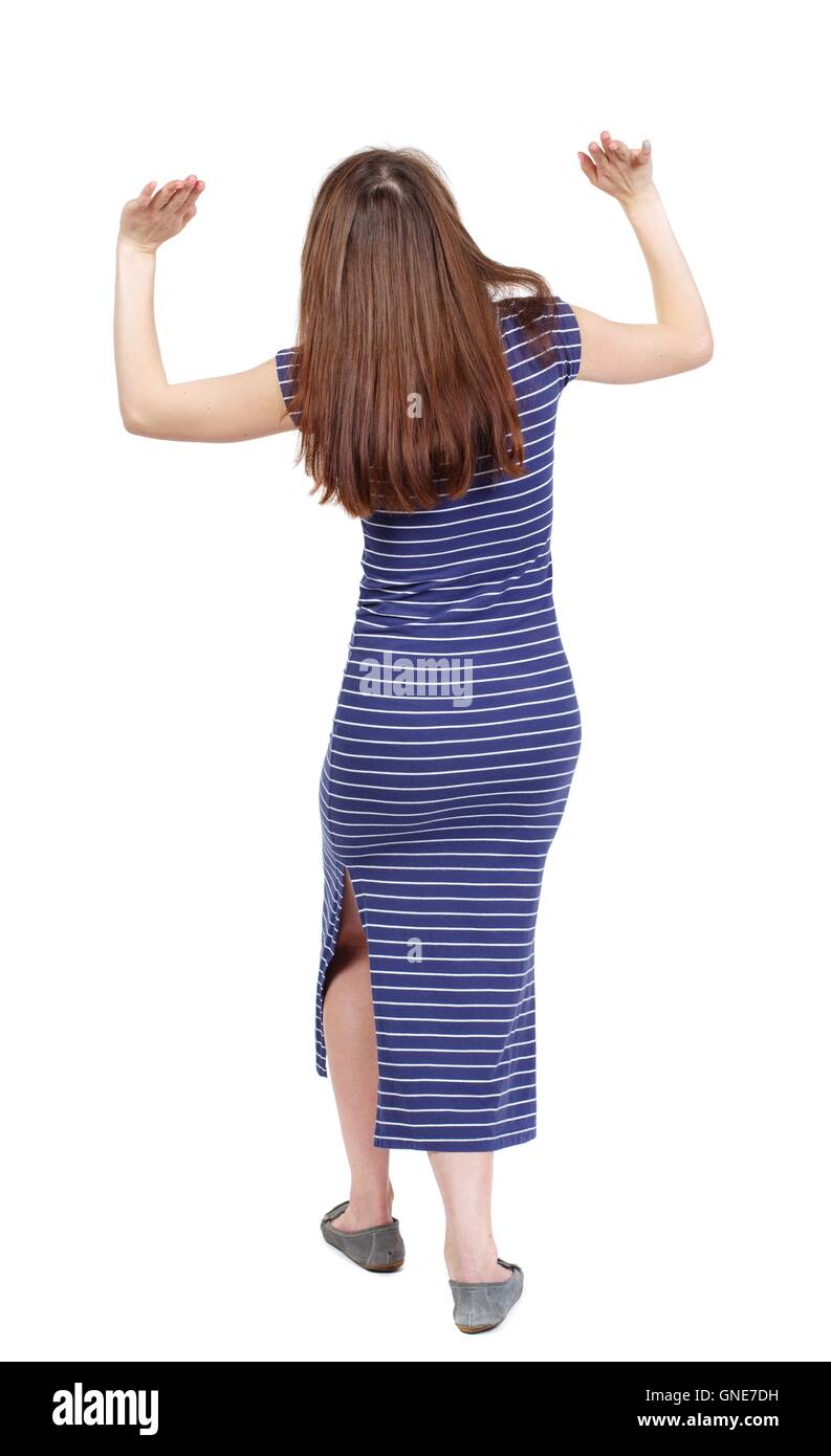 back view of woman protects hands from what is falling Stock Photo - Alamy
