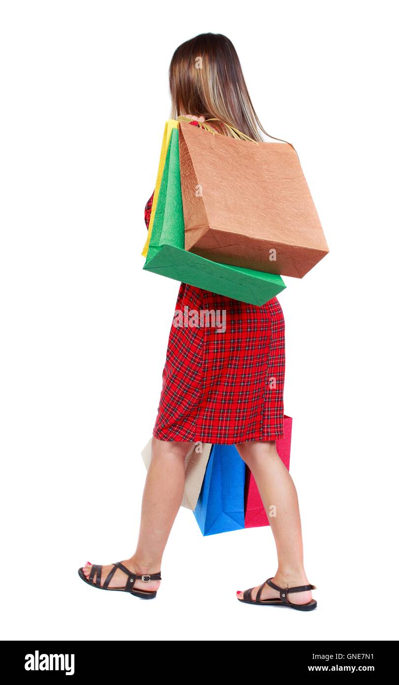 back view of going woman with shopping bags Stock Photo - Alamy