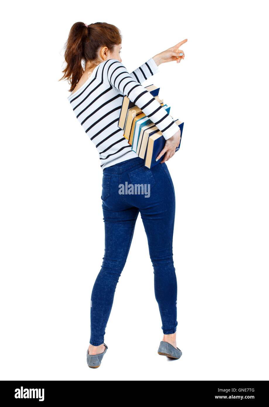 Girl with a stack of books points the finger Stock Photo - Alamy