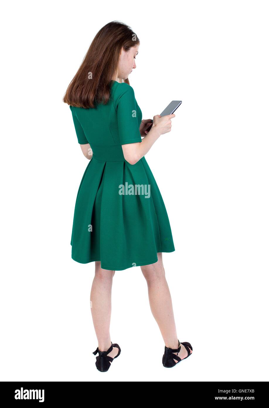 back view of standing young beautiful woman using a mobile phon Stock ...