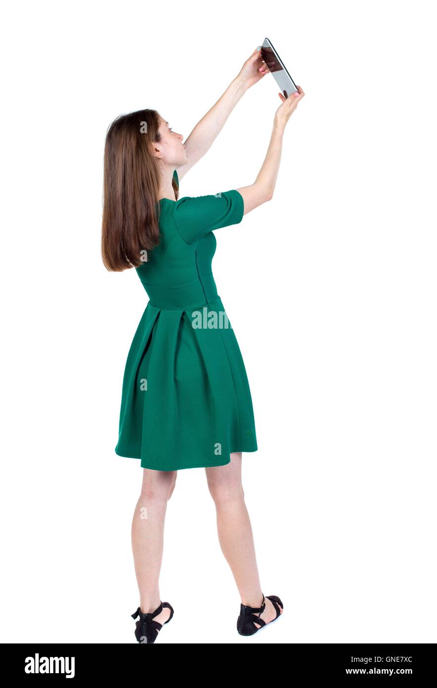 back view of standing young beautiful woman using a mobile pho Stock ...