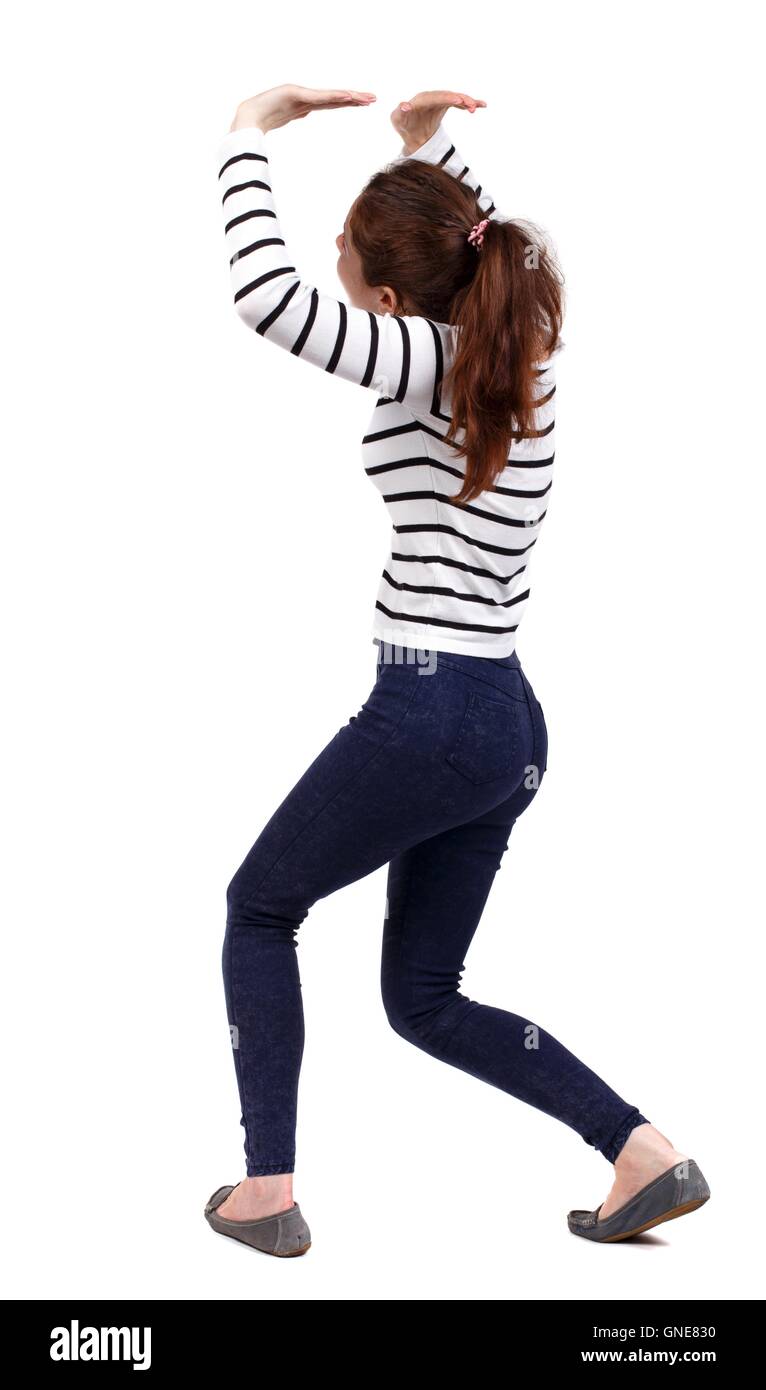 back view of woman protects hands from what is falling Stock Photo - Alamy