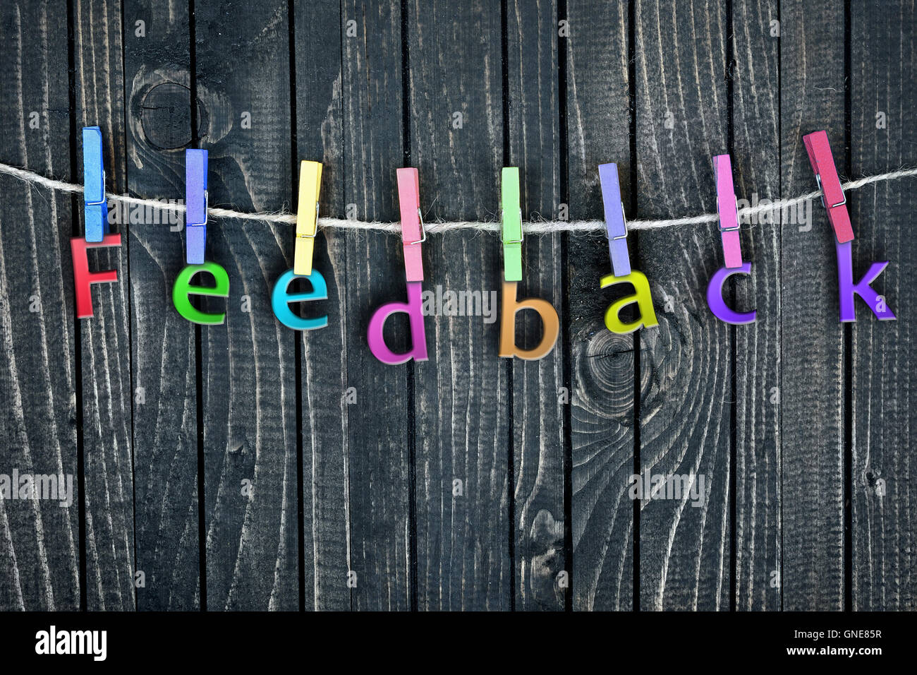 Feedback word hanging on clips and wooden wall Stock Photo - Alamy
