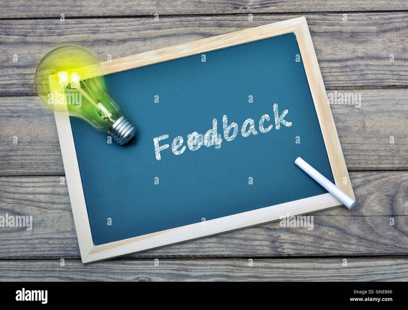 Feedback text on school board and glowing light bulb Stock Photo - Alamy