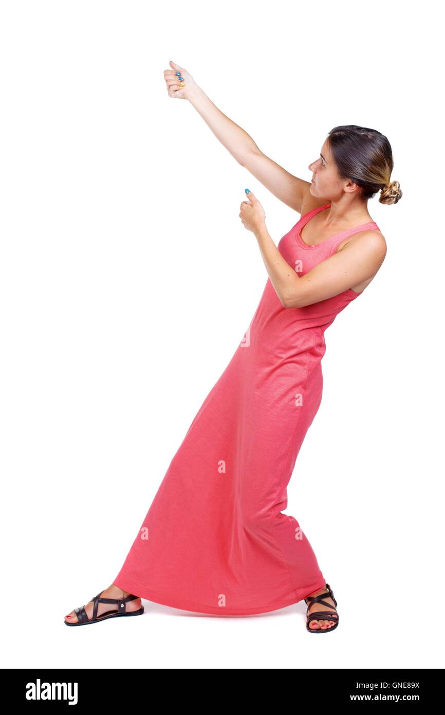 back view of standing girl pulling a rope from the top or cling Stock ...