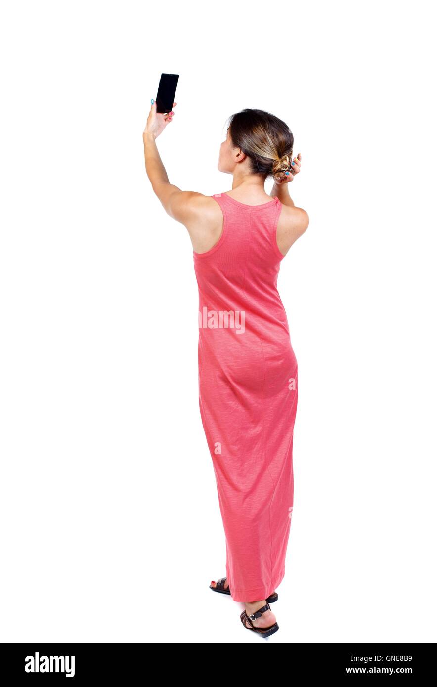 back view of standing young beautiful woman using a mobile pho Stock ...