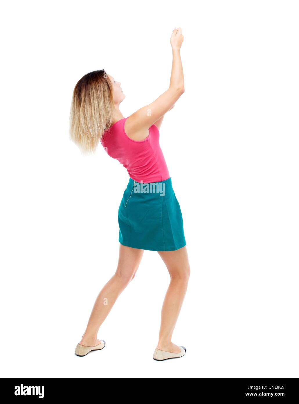 back view of standing girl pulling a rope from the top or cling Stock ...