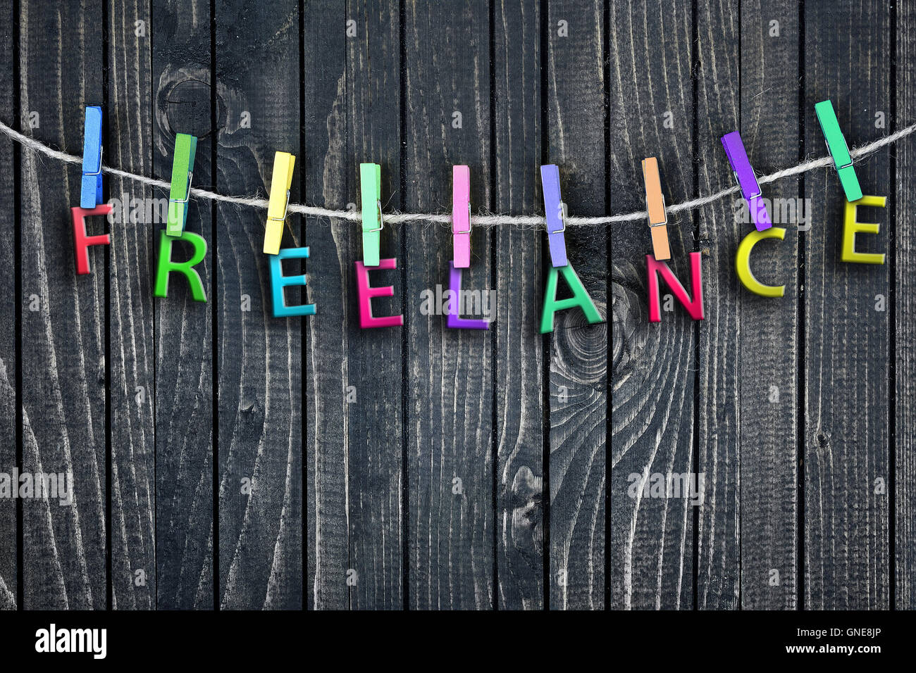Freelance word hanging on clips and wooden wall Stock Photo - Alamy