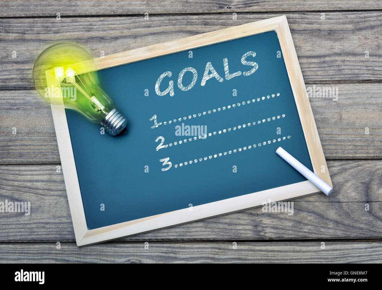 Goals text on school board and glowing light bulb Stock Photo - Alamy